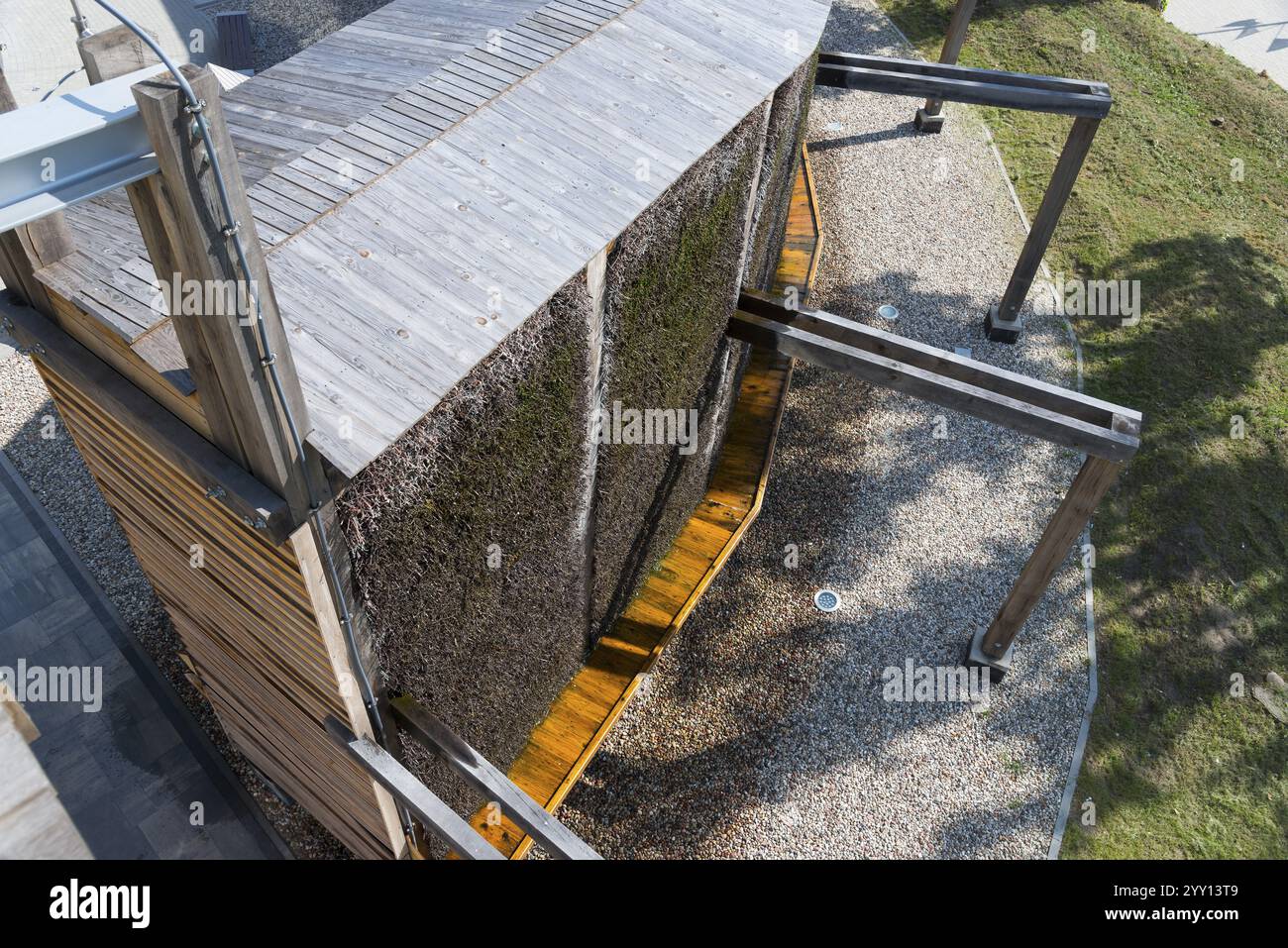 Modern wooden structure with gravel floor and shade, surrounded by ...