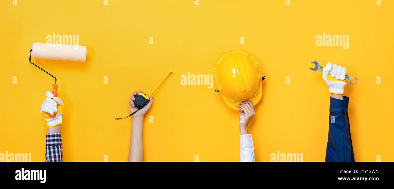 Hands holding construction tools and equipment in yellow banner ...