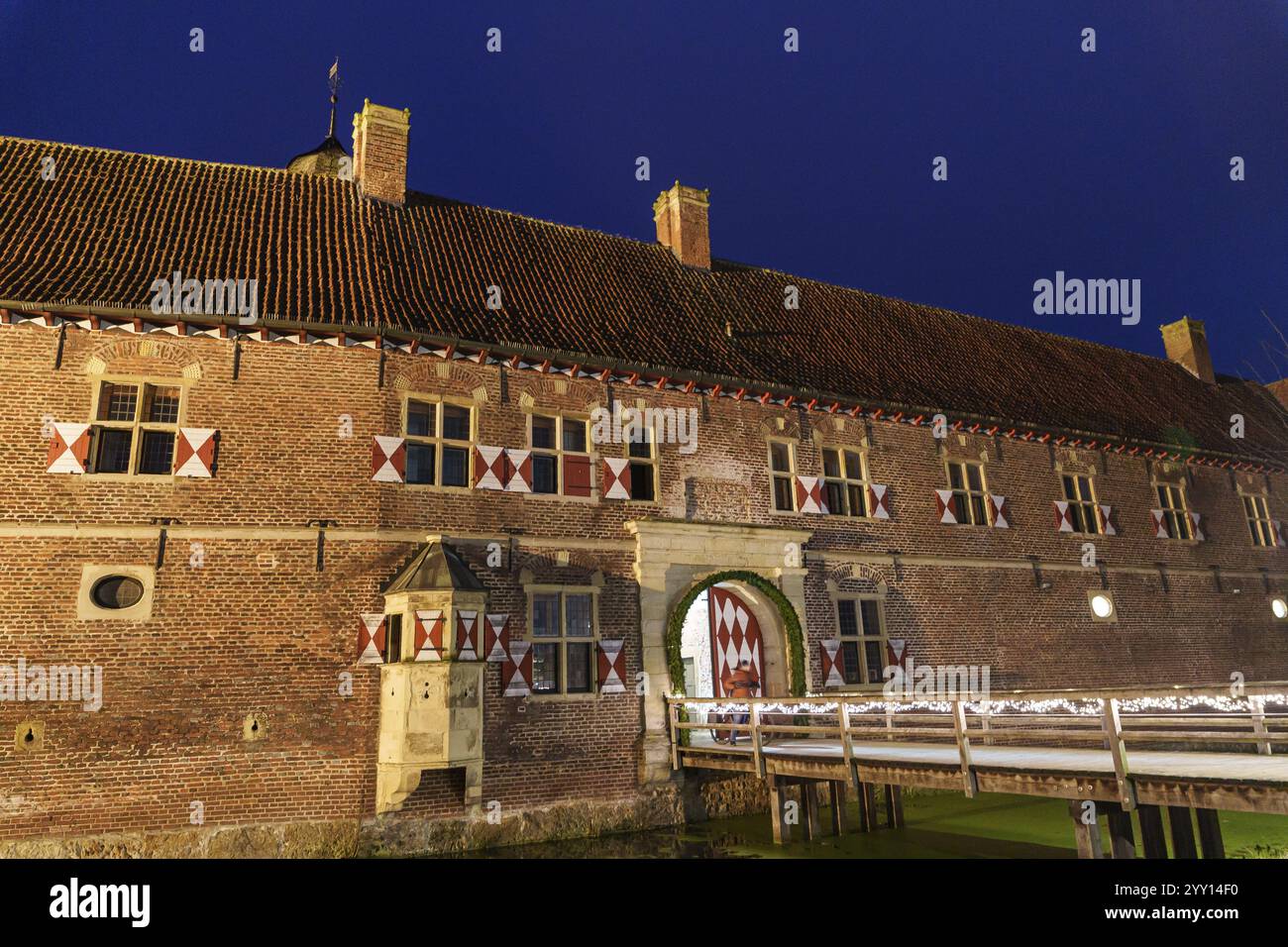 Pretty brick building at night, stylish fairy lights adorn the entrance ...