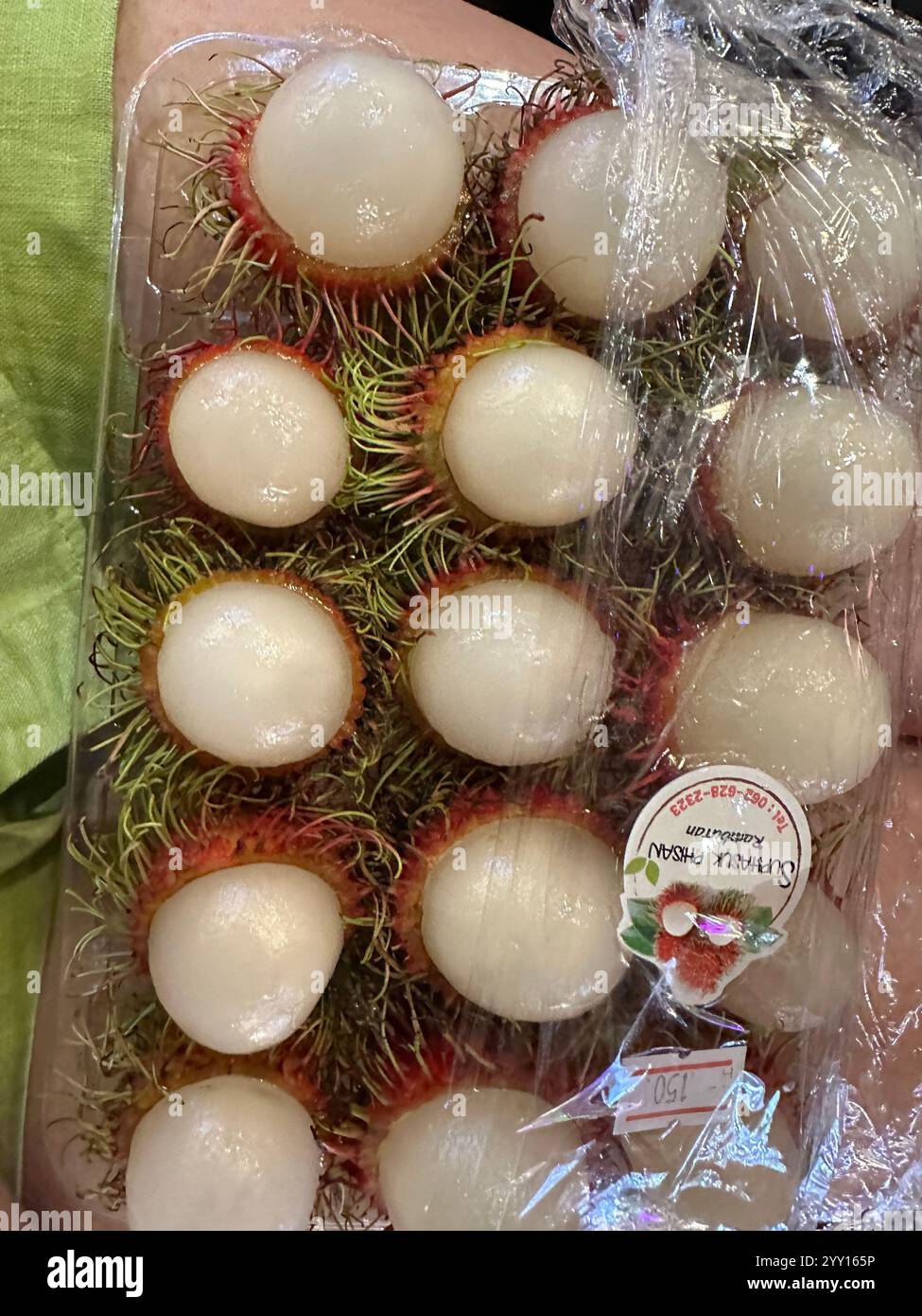 A plastic container filled with rambutan fruit Stock Photo - Alamy