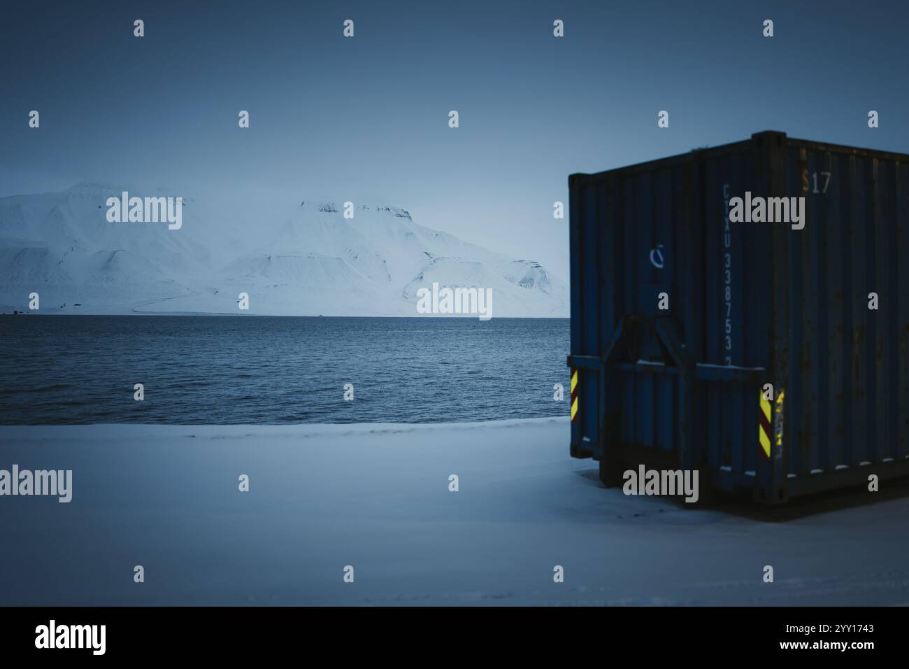 Snowy mountains behind shipping container in Longyearbyen, Svalbard ...