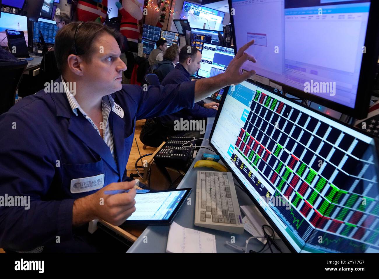 Trader Michael Milano works on the floor of the New York Stock Exchange ...