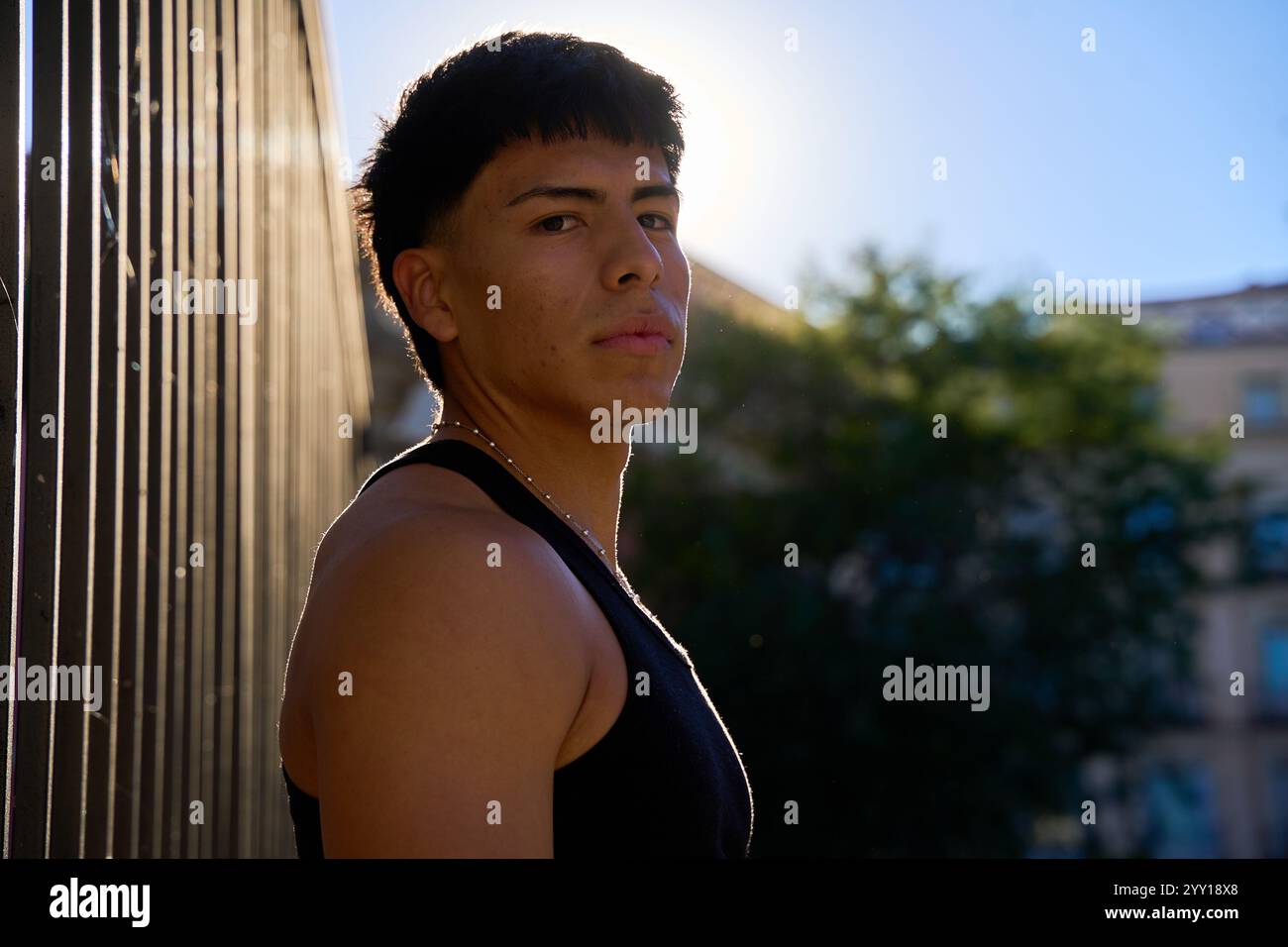Young Latino man in profile with sunlight background outdoors Stock ...