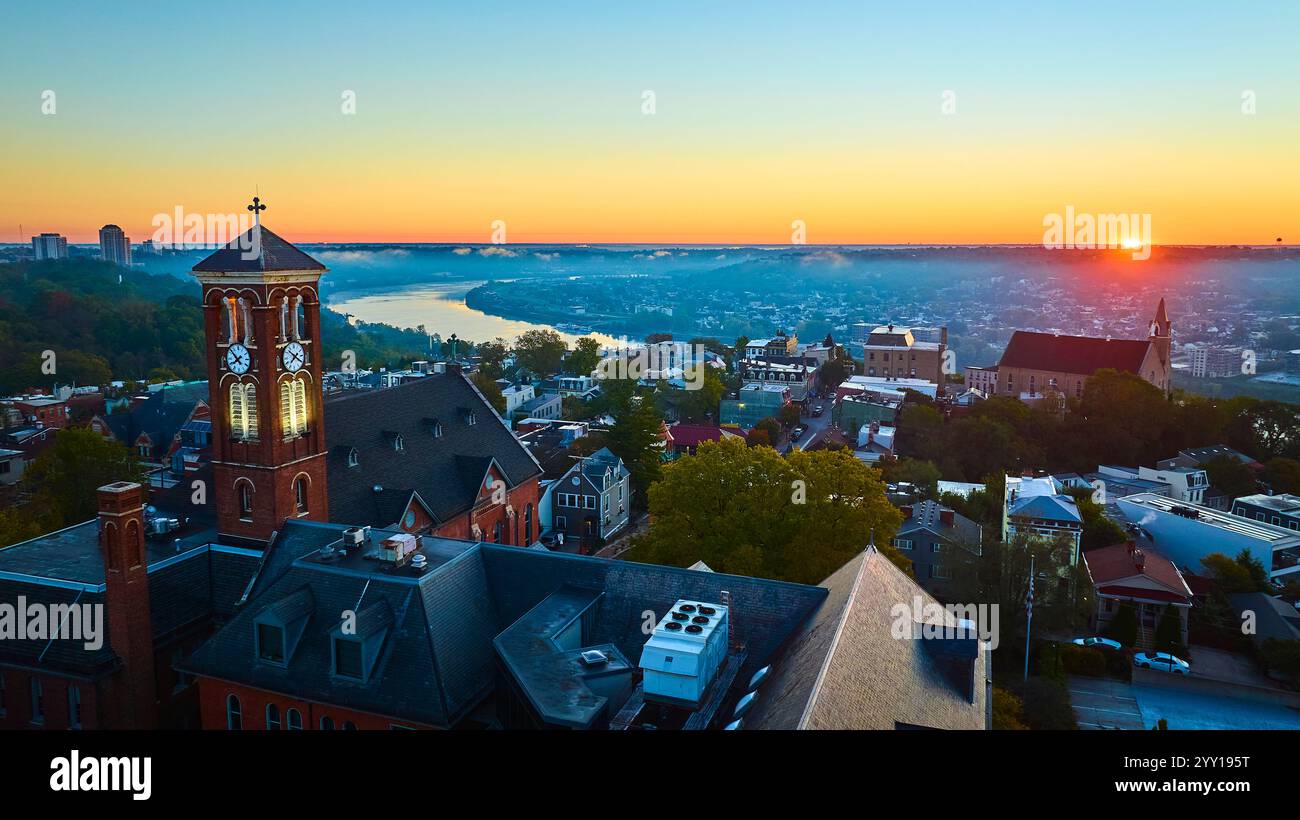 Aerial of Church Clock Tower at Sunrise Over River and Town in ...