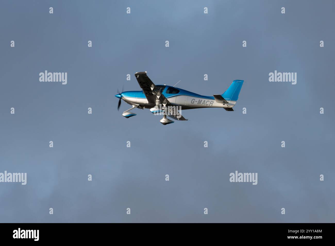 light aircraft with single engine and propeller wheels down just after ...