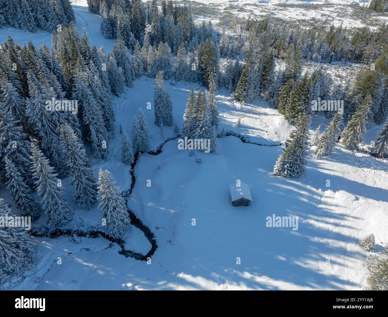 aerial photo of a little creek winding in the snowy landscape of the ...