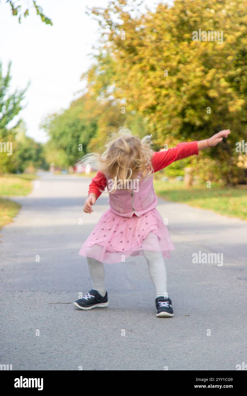 The child fell on the road and hit her leg. Selective focus. kid Stock ...