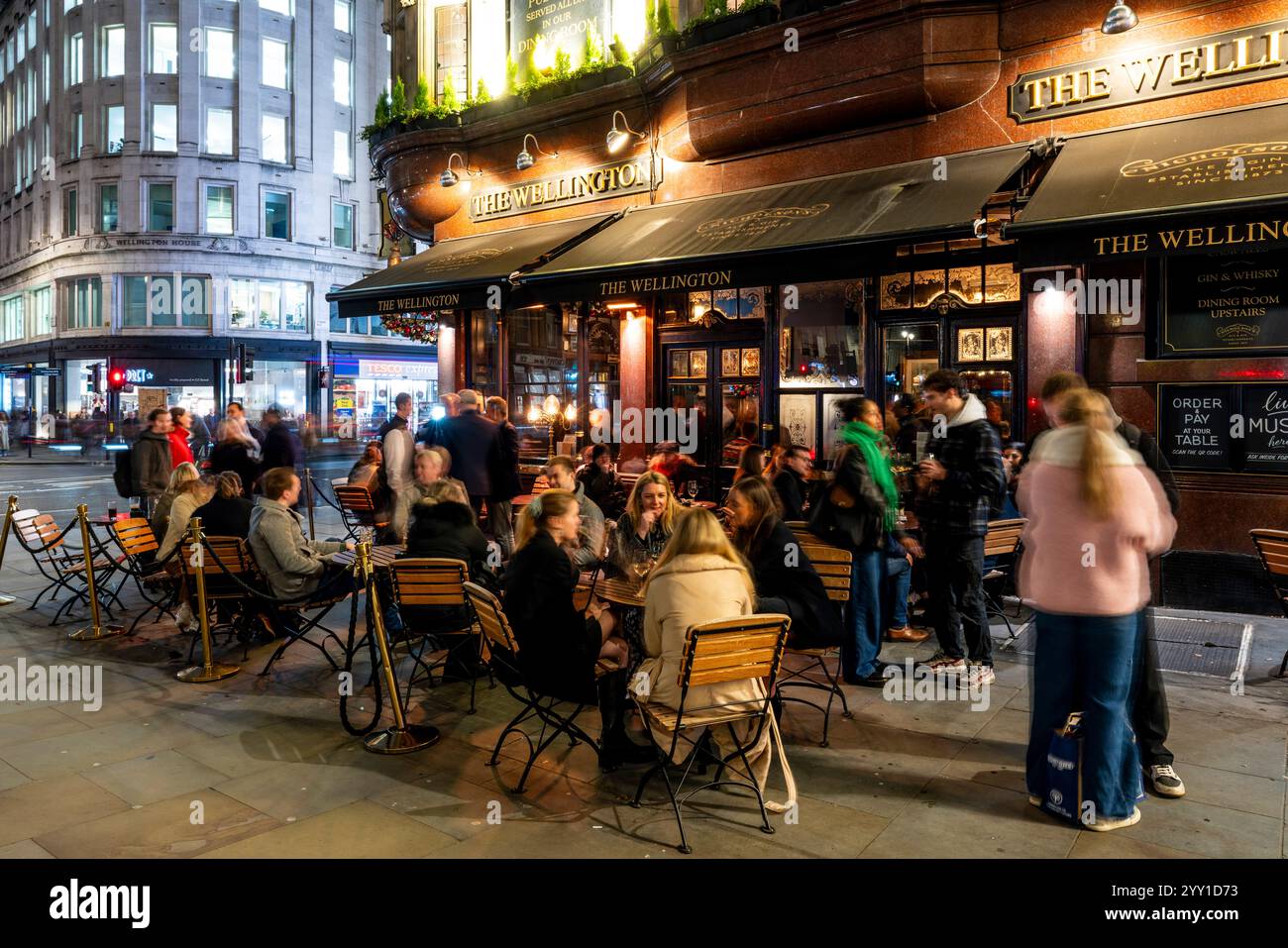 A Group of Young Women Sitting Outside The Wellington Pub Drinking ...