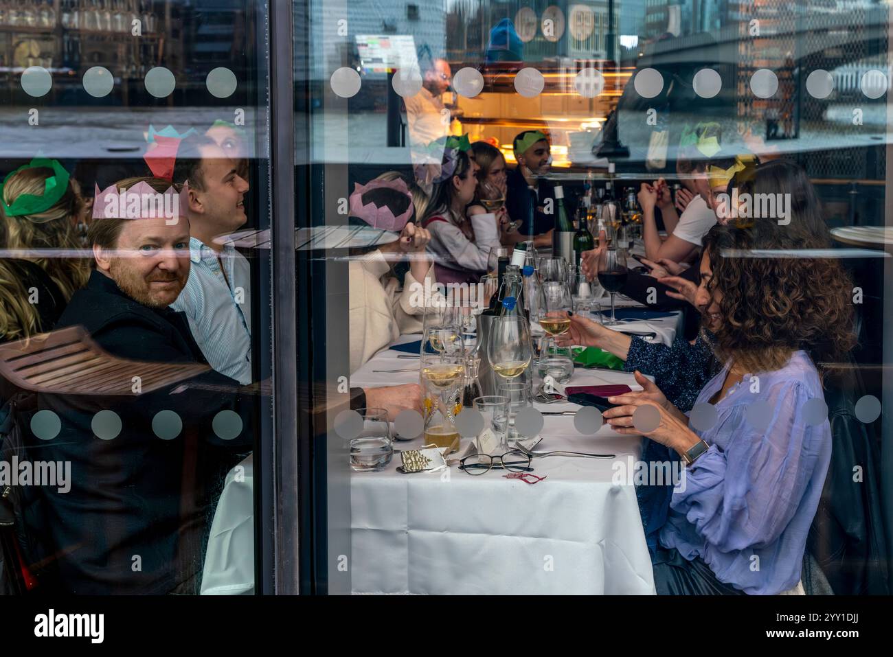 A Group of People Sit Inside A Restaurant For A Christmas Party, London ...