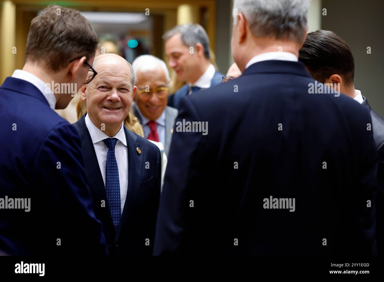 Germany's Chancellor Olaf Scholz, second left, arrives for a round ...