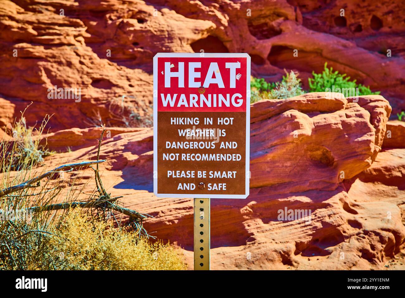 Desert Heat Warning Sign with Red Rock Formations Eye-Level View Stock ...