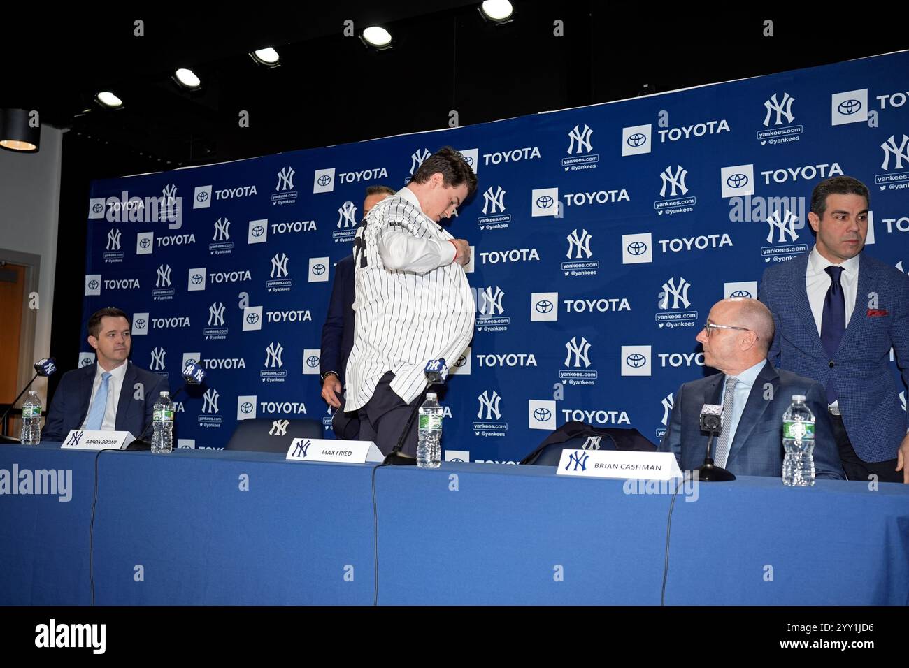 New York Yankees' Max Fried puts on a jersey as general manager Brian ...