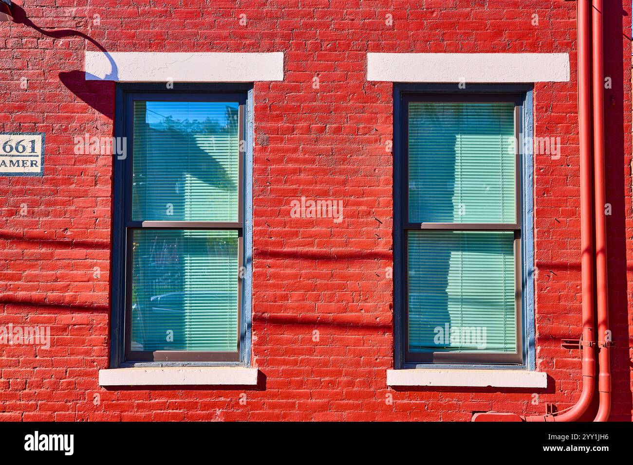Red Brick Wall with Blue Trim Windows and Number 661 Eye-Level View ...