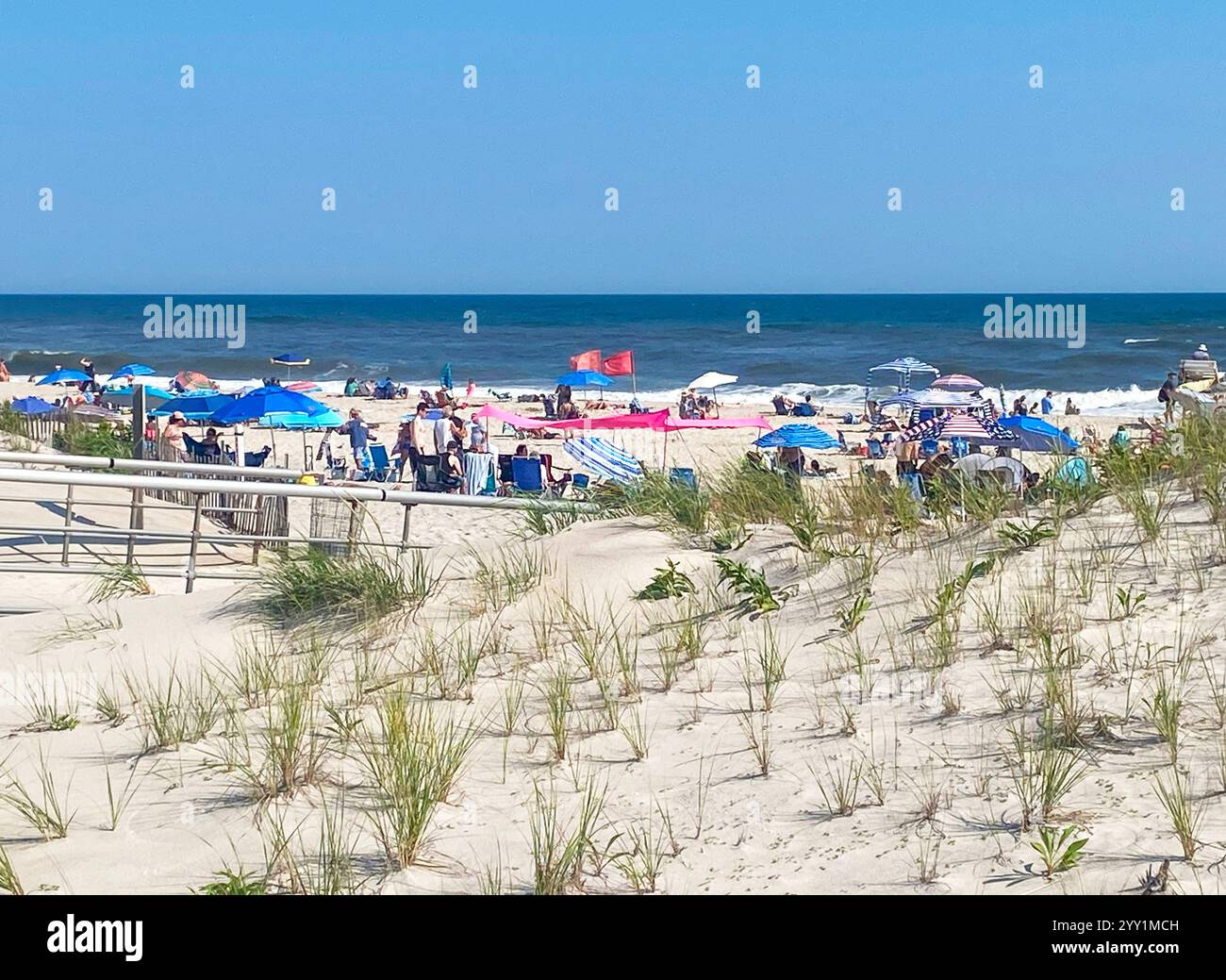Babylon, New York, USA - 10 August 2024: Groups of people enjoy a sunny ...