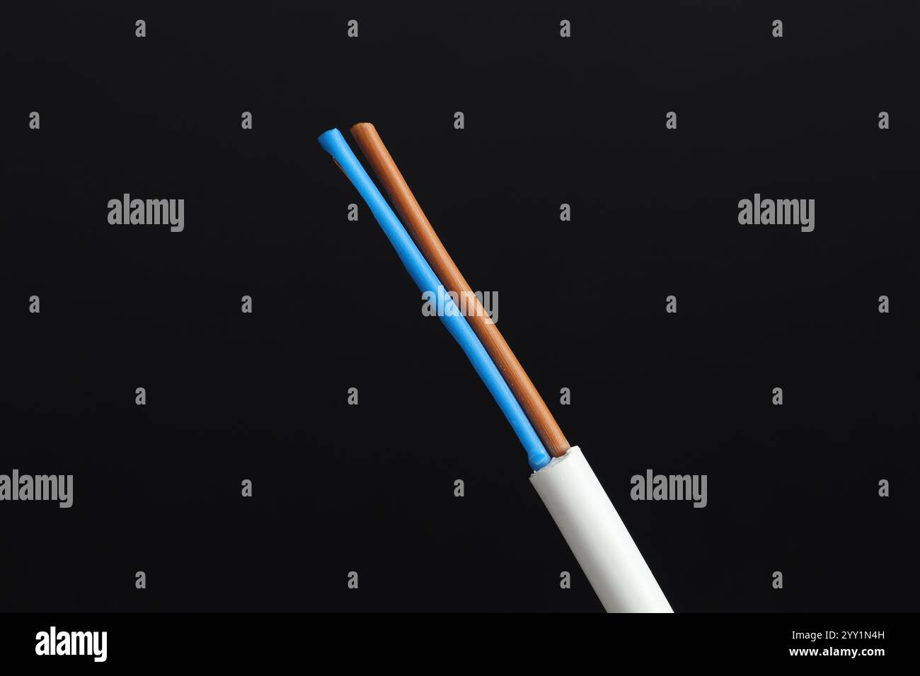 White stripped electrical wire on black background, closeup Stock Photo ...