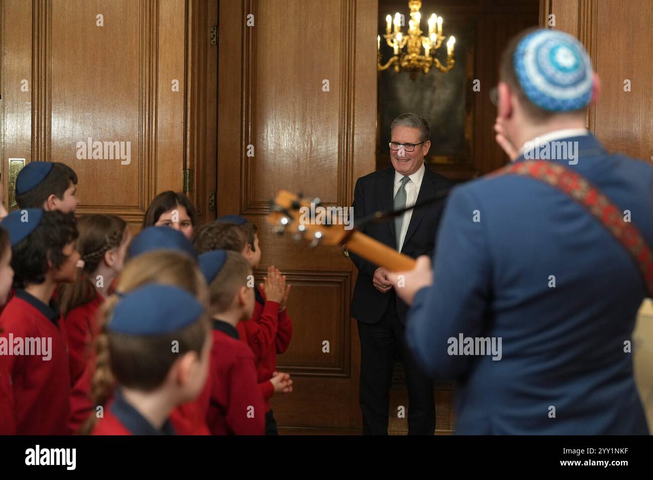 Prime Minister Sir Keir Starmer looks at the choir of Alma Primary as ...