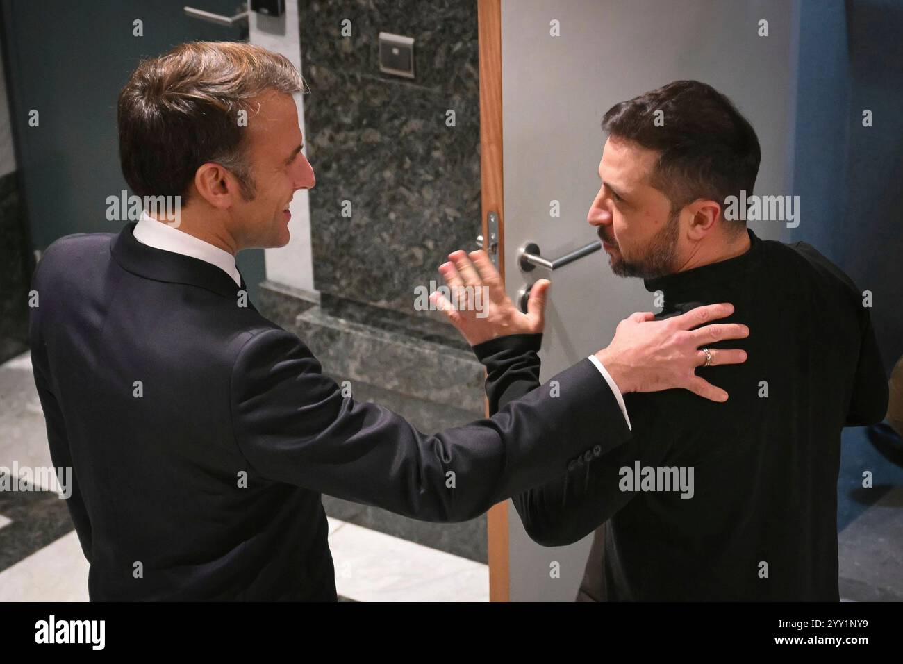 French President Emmanuel Macron, left, speaks with Ukraine's President ...