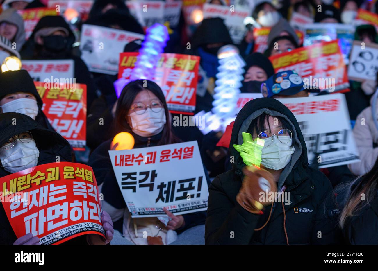 Seoul, South Korea. 18th Dec, 2024. Protesters wave light sticks with ...