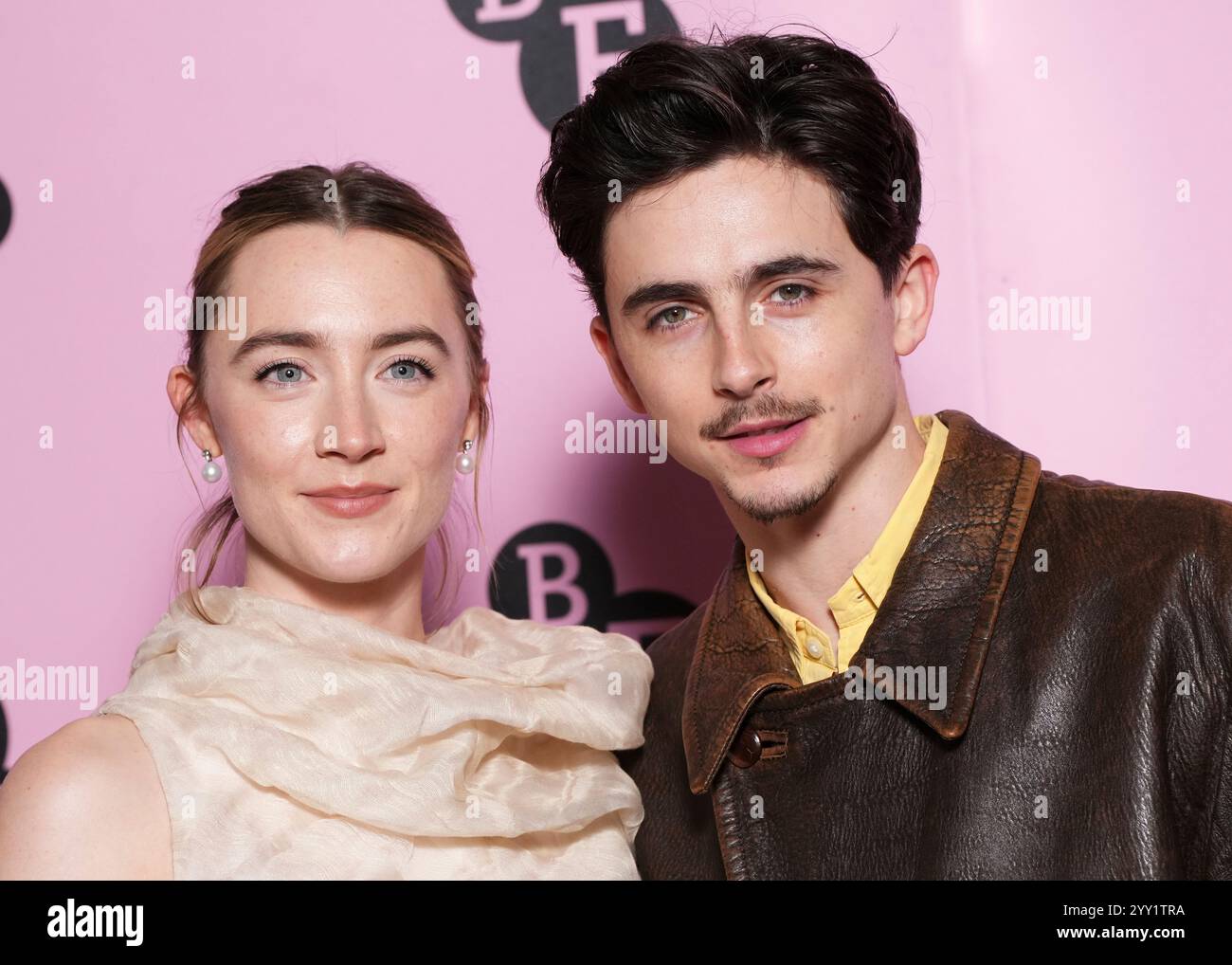 Saoirse Ronan, left, and Timothee Chalamet pose for photographers upon ...