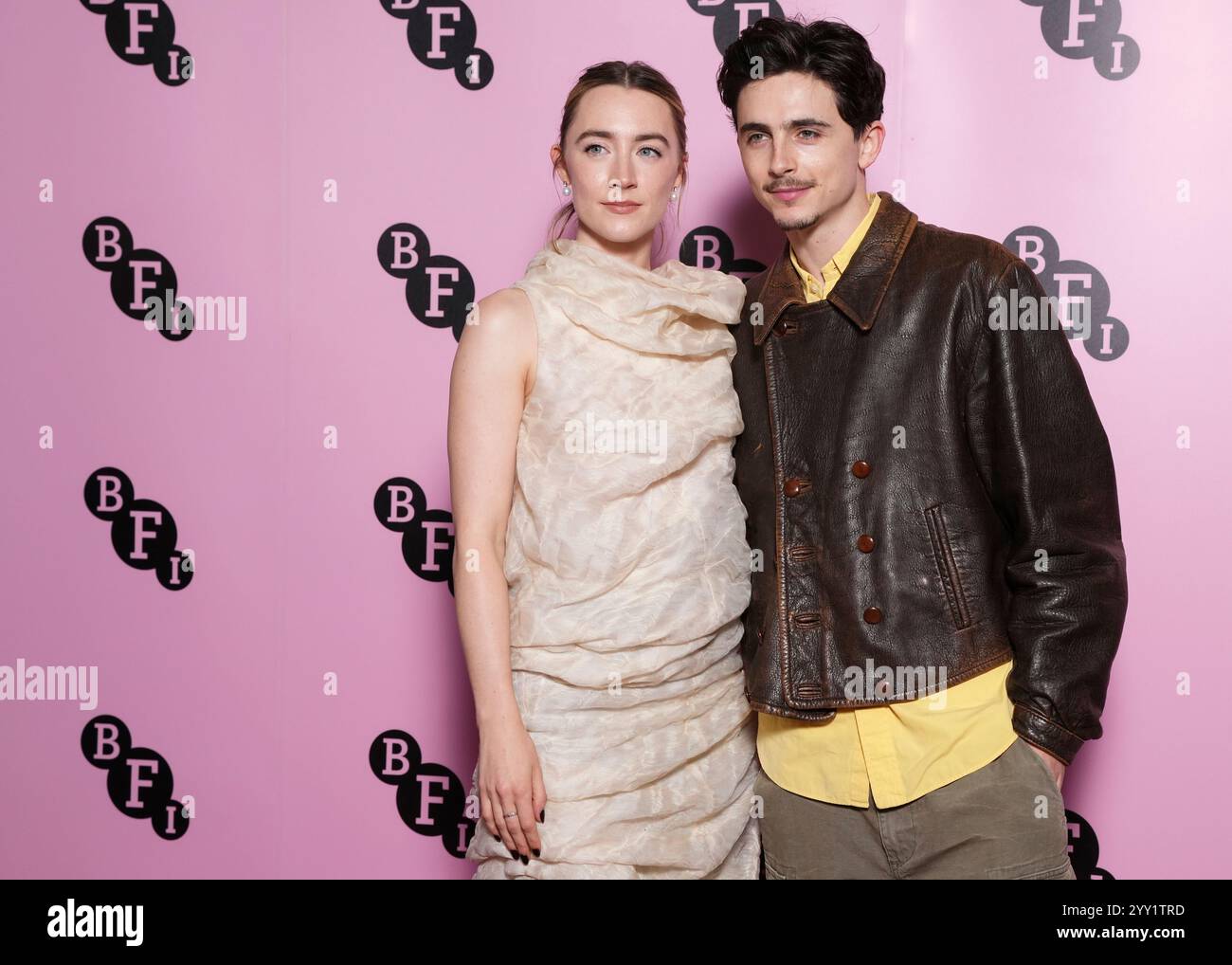 Saoirse Ronan, left, and Timothee Chalamet pose for photographers upon ...