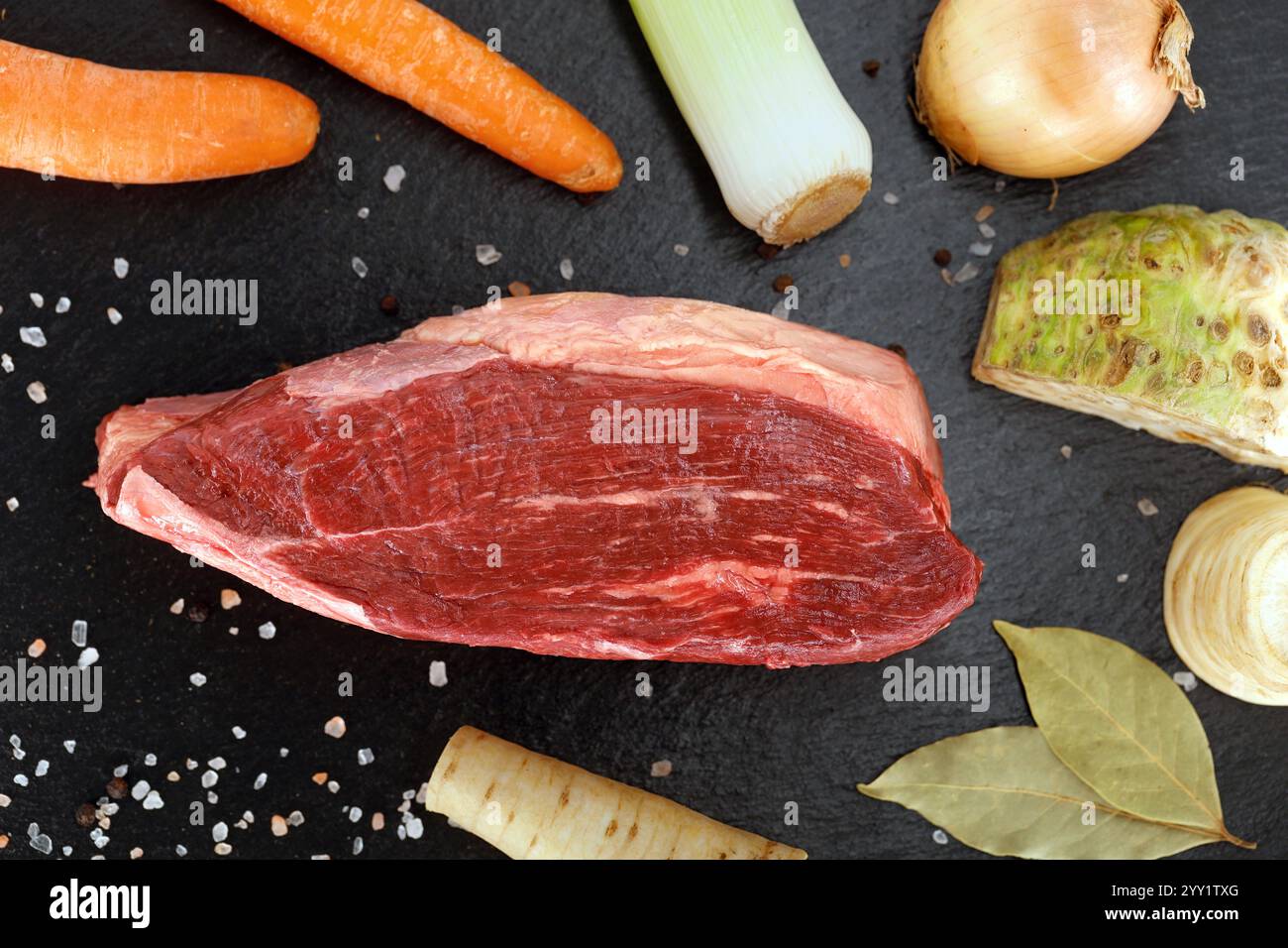 fresh piece of raw beef from the cap of rump with root vegetables on ...