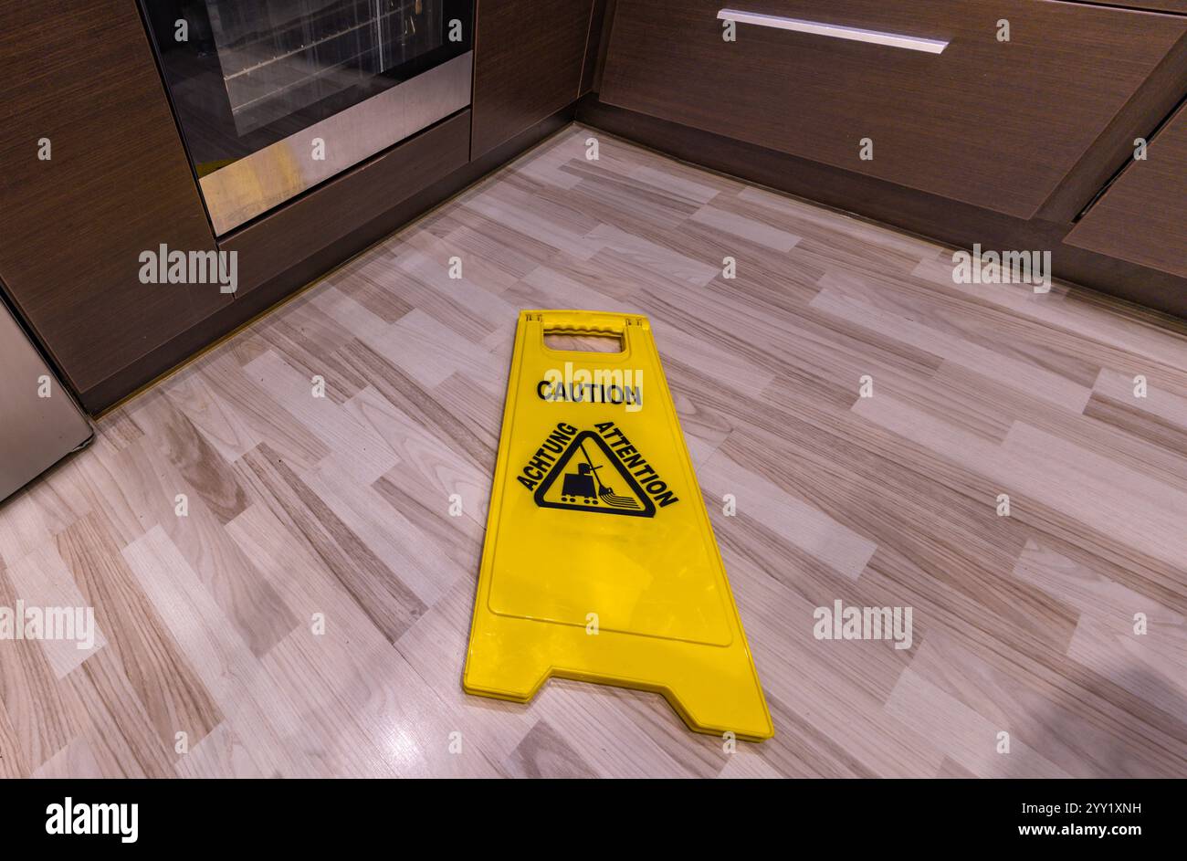 Warning for customers, slippery floor, yellow information board ...