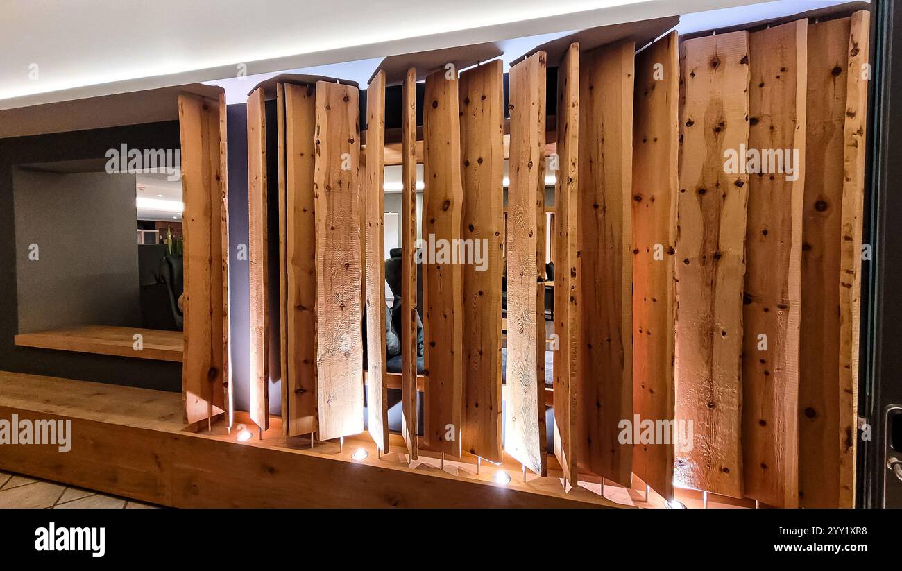 Decorative moving wooden wall in a modern house. Raw wood in interior ...