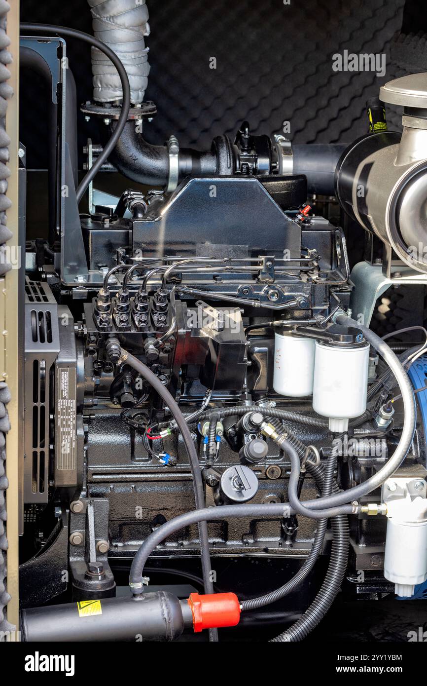 Deep within an industrial workspace, a robust diesel engine is ...
