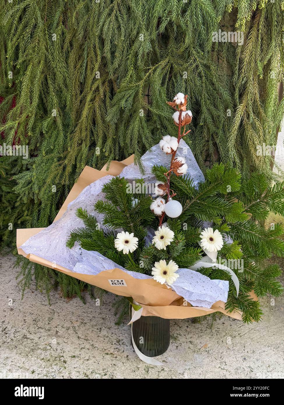 This photo showcases a gorgeous winter bouquet placed against a ...