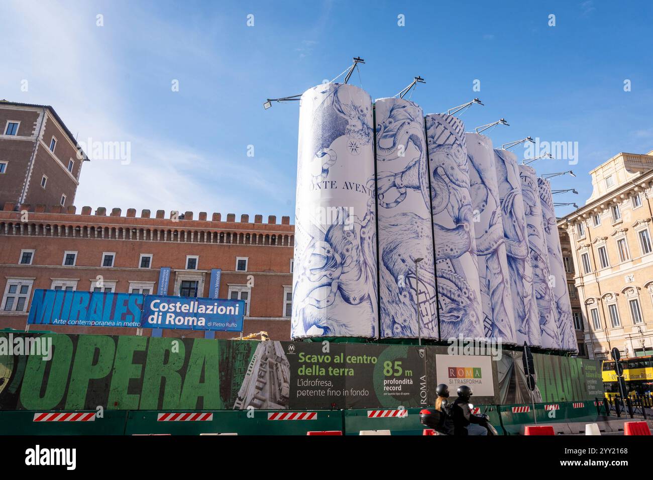 View of cars passing next to "Constellations of Rome", the title of the ...