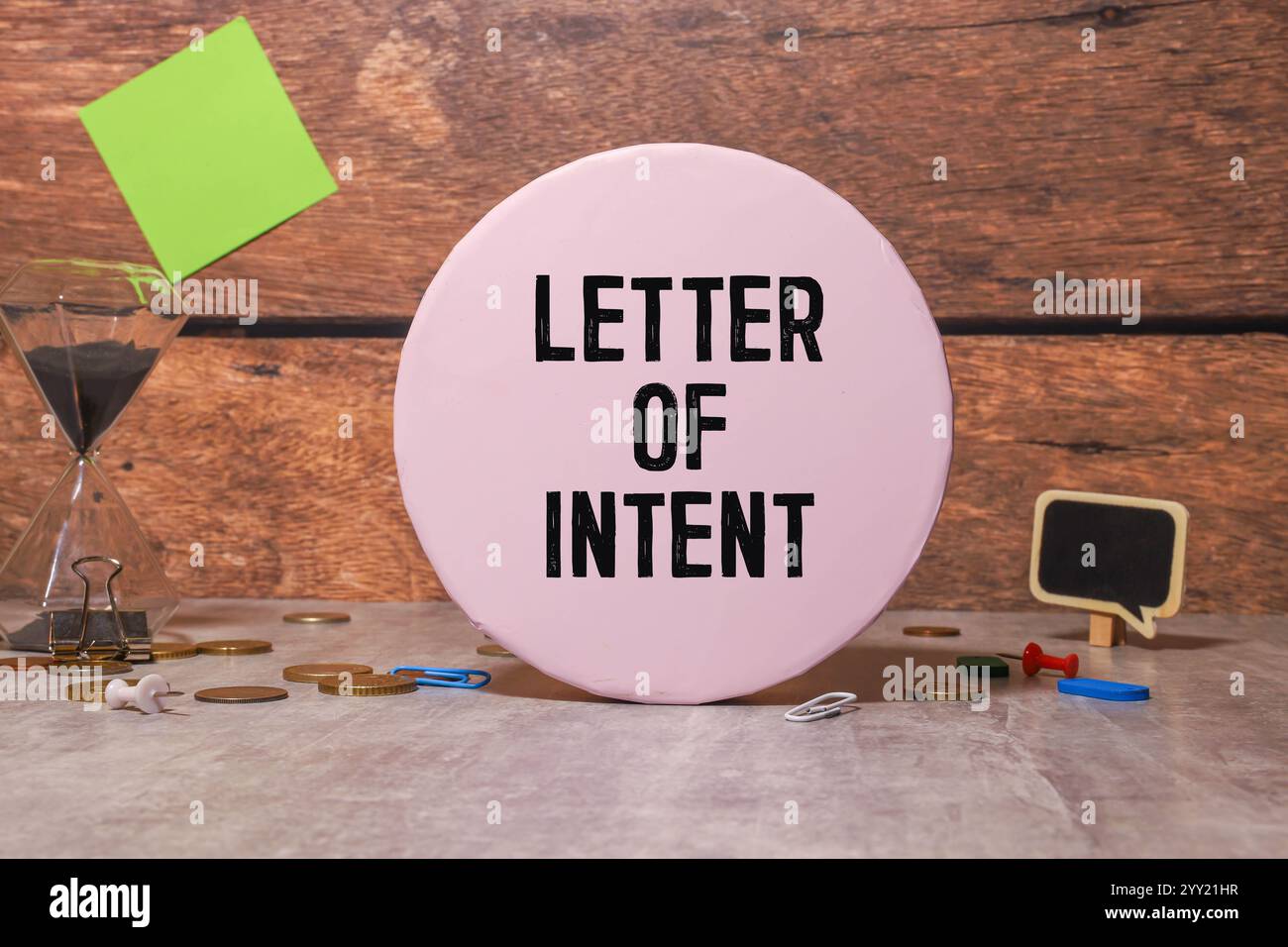 LETTER OF INTENT text on a paper clipboard with magnifier and keyboard ...