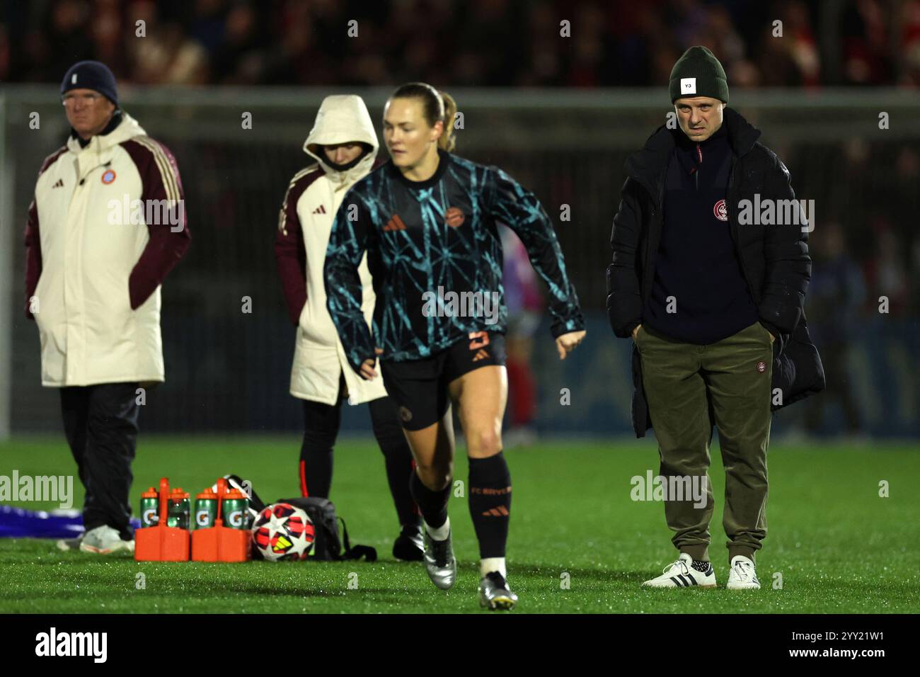 Bayern Munich's coach Alexander Straus watches his players warm up ...