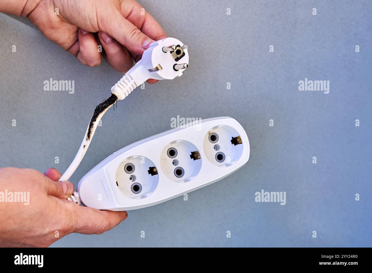 Burnt power cable with tee socket after overloading with electrical ...