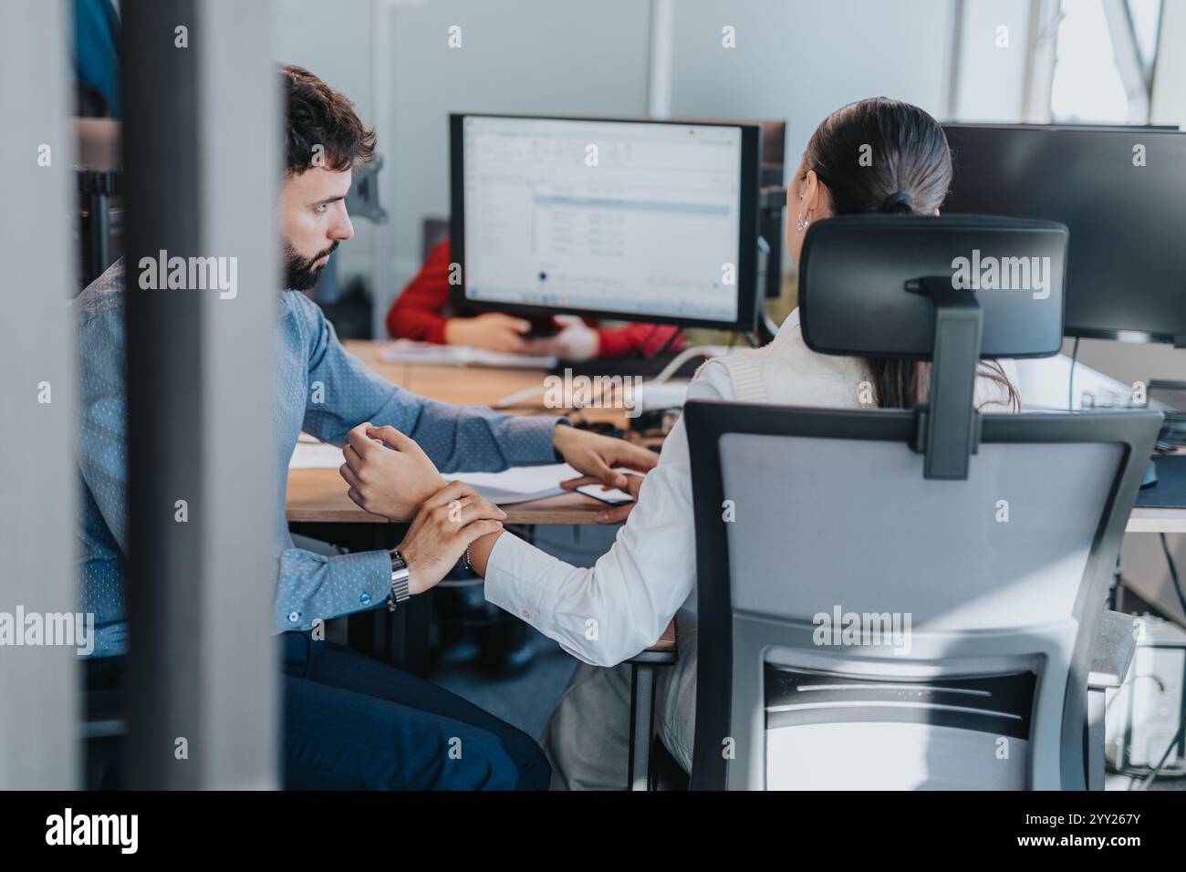 Multicultural team members collaborating in an office, showcasing ...