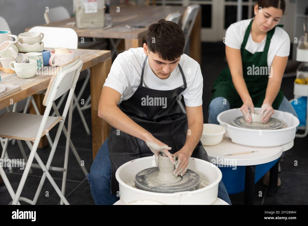Young man working with pottery wheel Stock Photo - Alamy