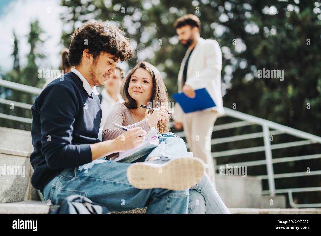 High school students engaged in outdoor learning with teacher guidance ...