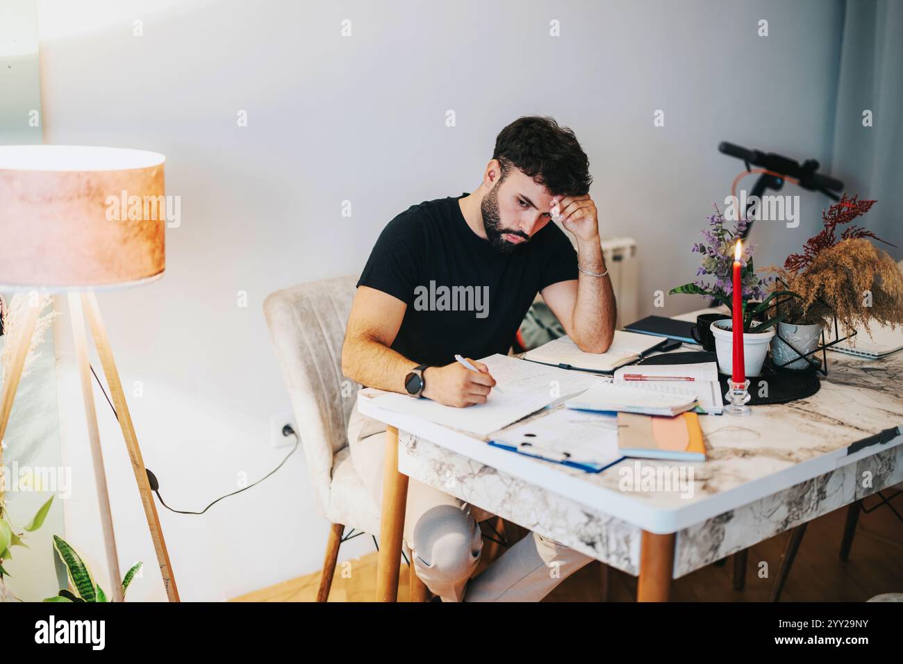 College student studying at home with focused concentration Stock Photo ...