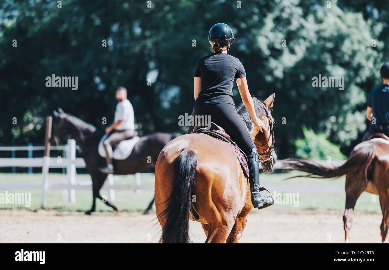 Horseback riders enjoying a peaceful afternoon lesson outdoors Stock ...