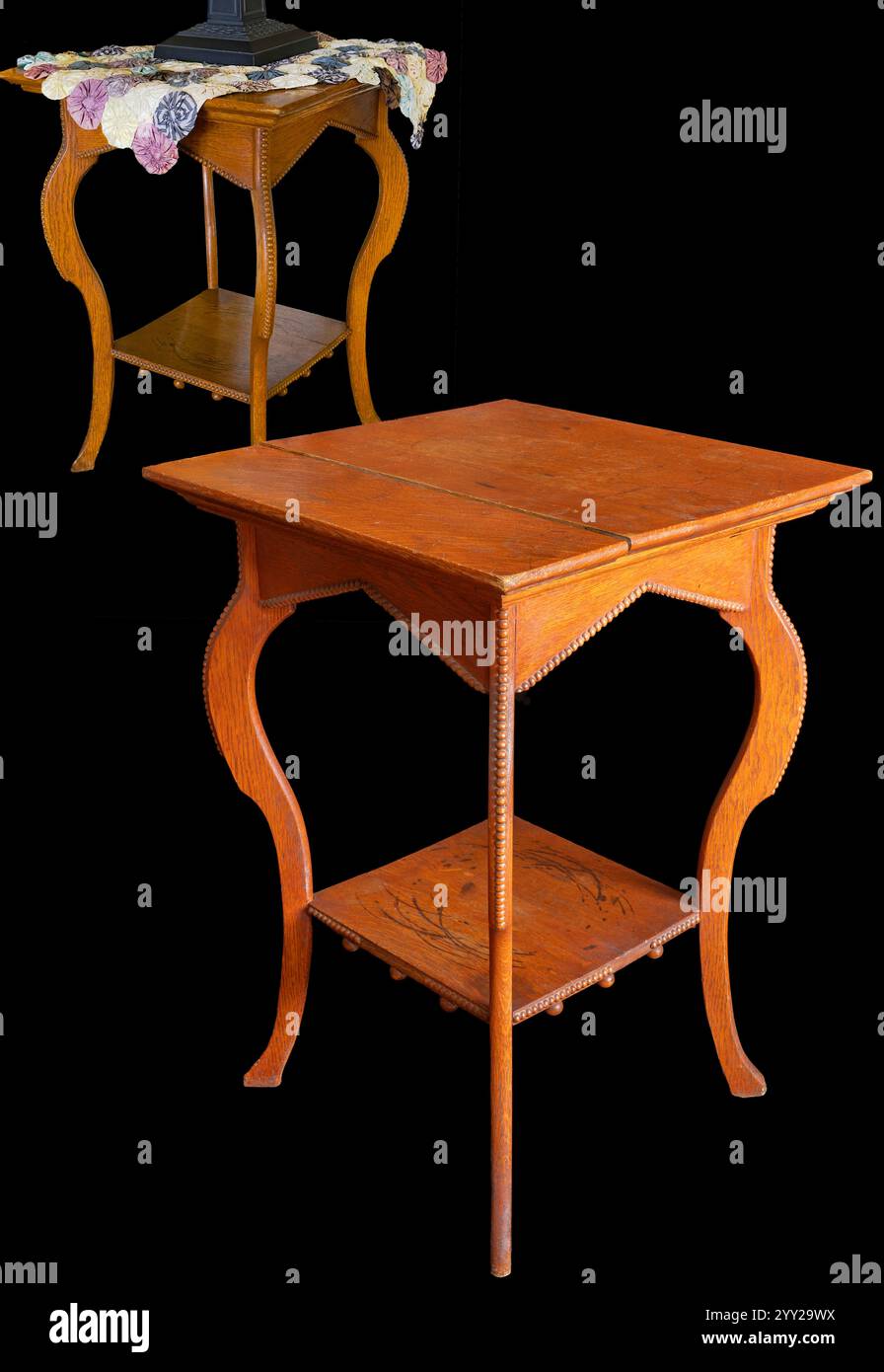 Antique wood table is on black background isolated showing curved legs ...