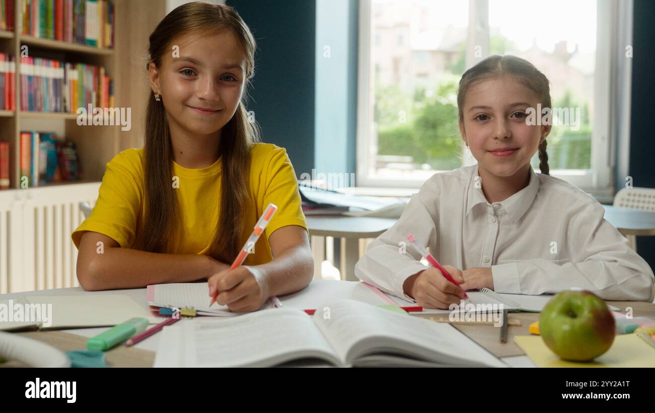 School kids two Caucasian little girls children schoolgirls classmates ...