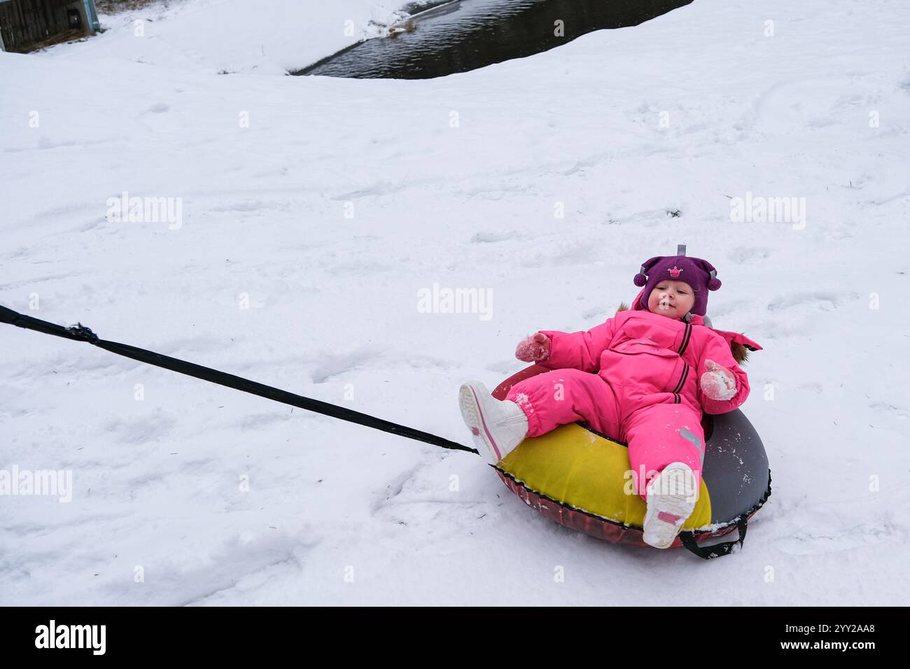 A child rides a tube down the mountain Stock Photo - Alamy