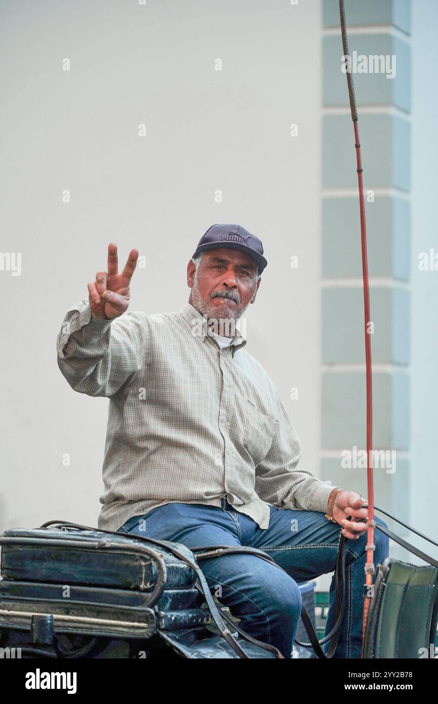 A local carriage driver in Alexandria, Egypt, gestures with a peace ...