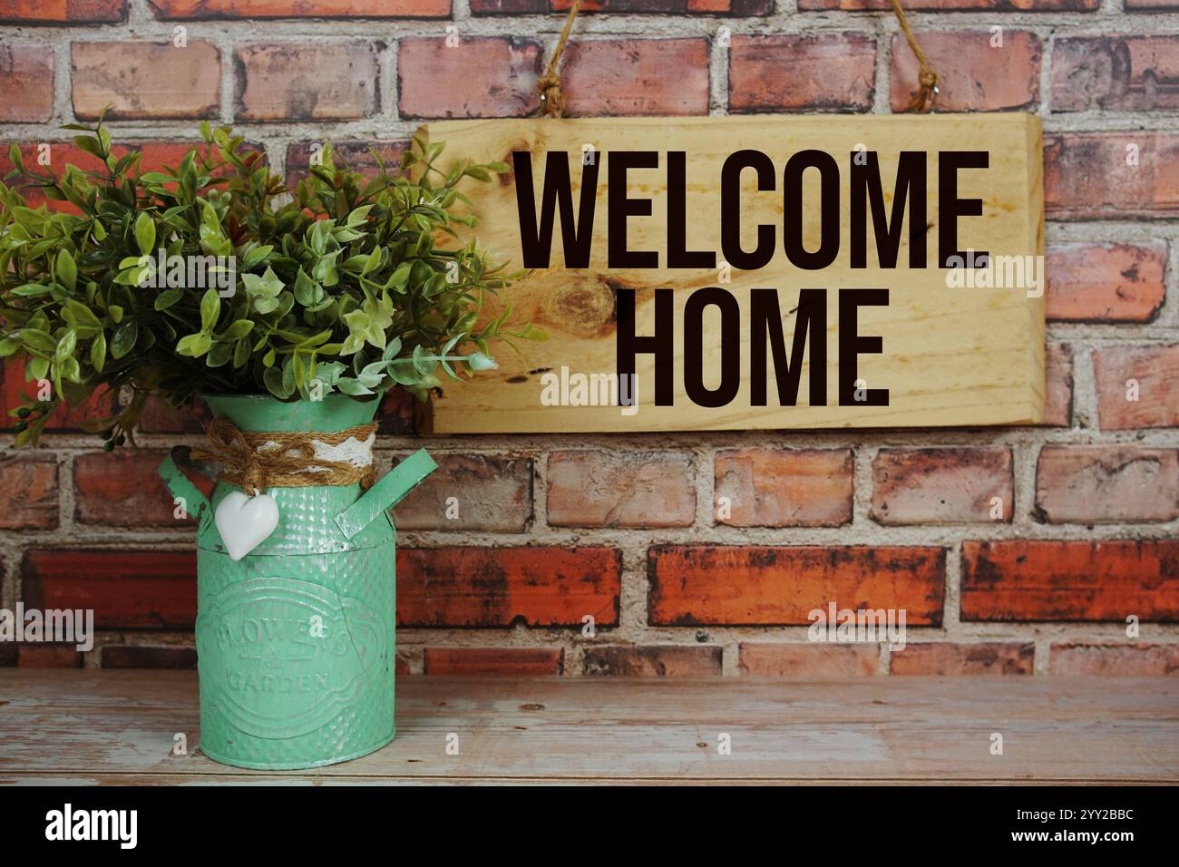 Welcome Home text on wooden sign hanging on old brick wall background ...