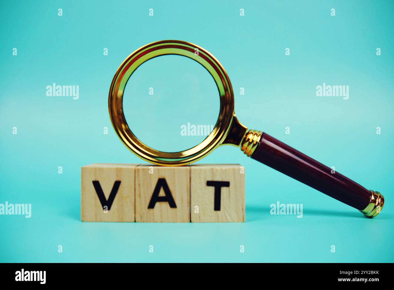 VAT with wooden blocks alphabet letters and Magnifying glass on blue ...