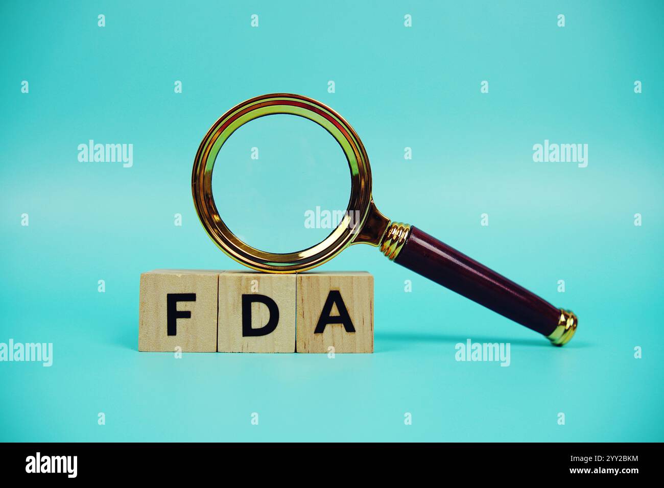 FDA with wooden blocks alphabet letters and Magnifying glass on blue ...