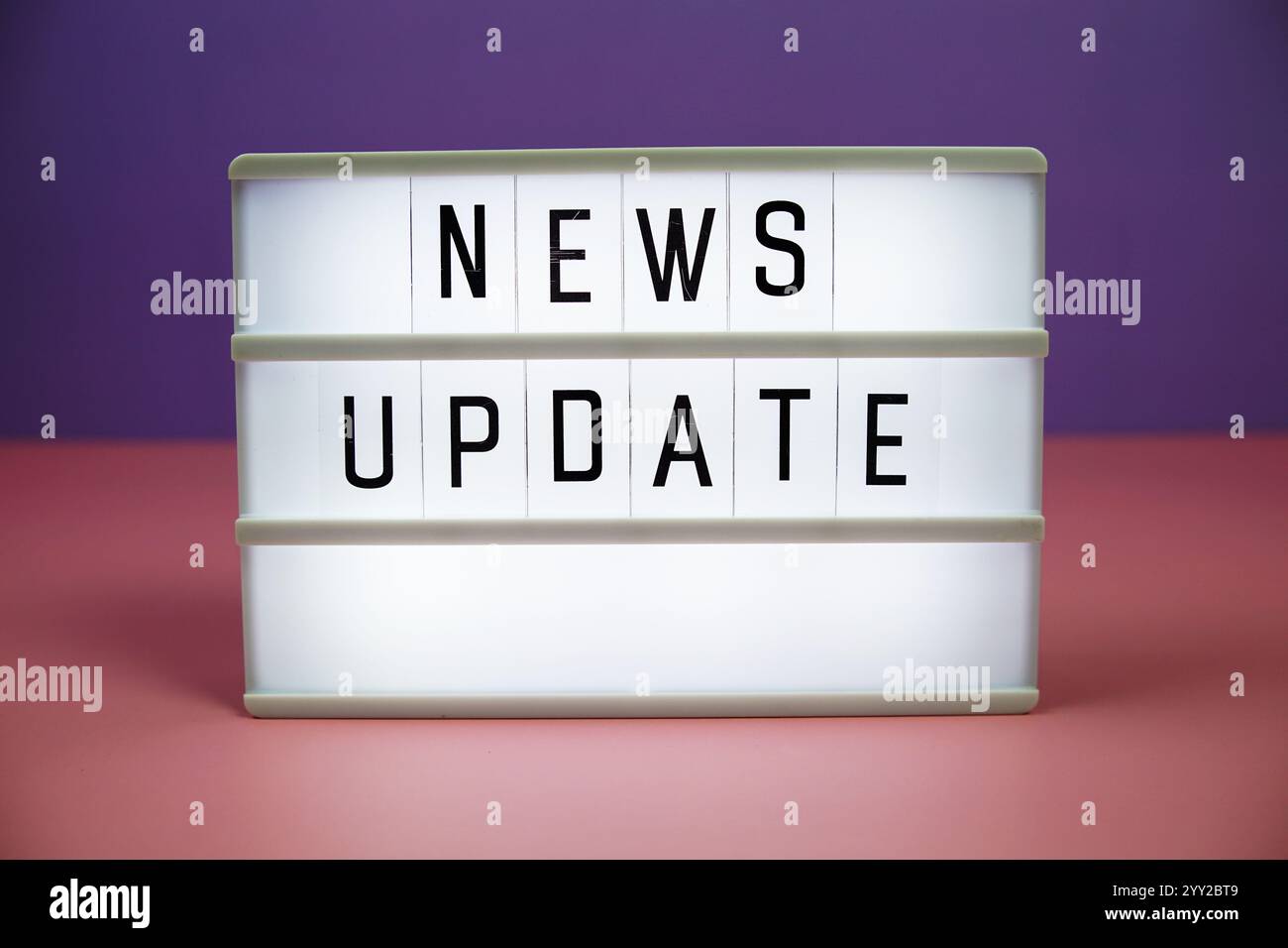 News Update letterboard text on LED Lightbox on pink and purple ...