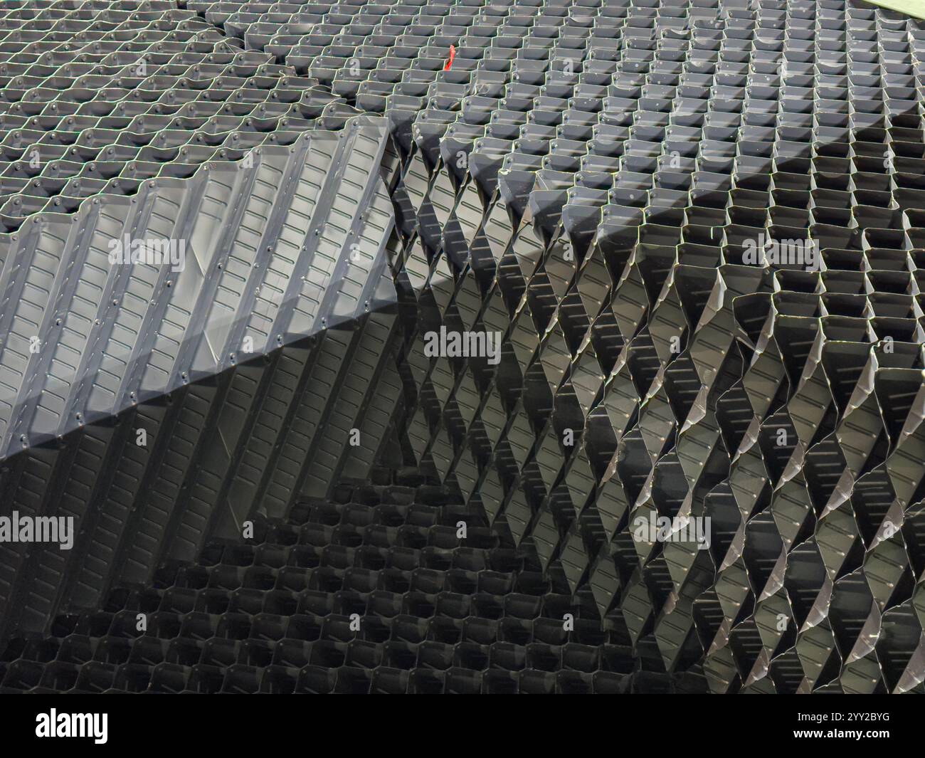 Close up of fabricated black plastic grid, mesh, material in a waste ...