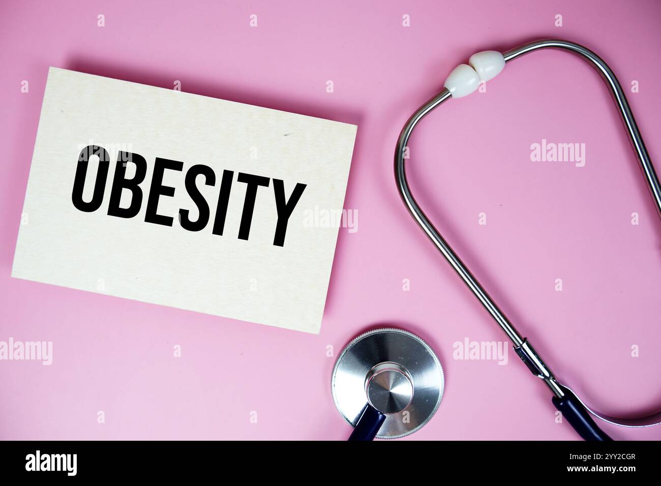 Obesity text with stethoscope on pink background, Healthy and wellness ...