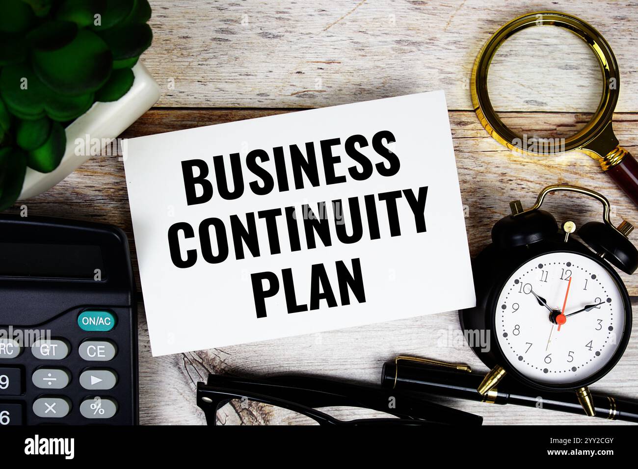 Business Continuity plan text with calculator, magnifying glass and ...