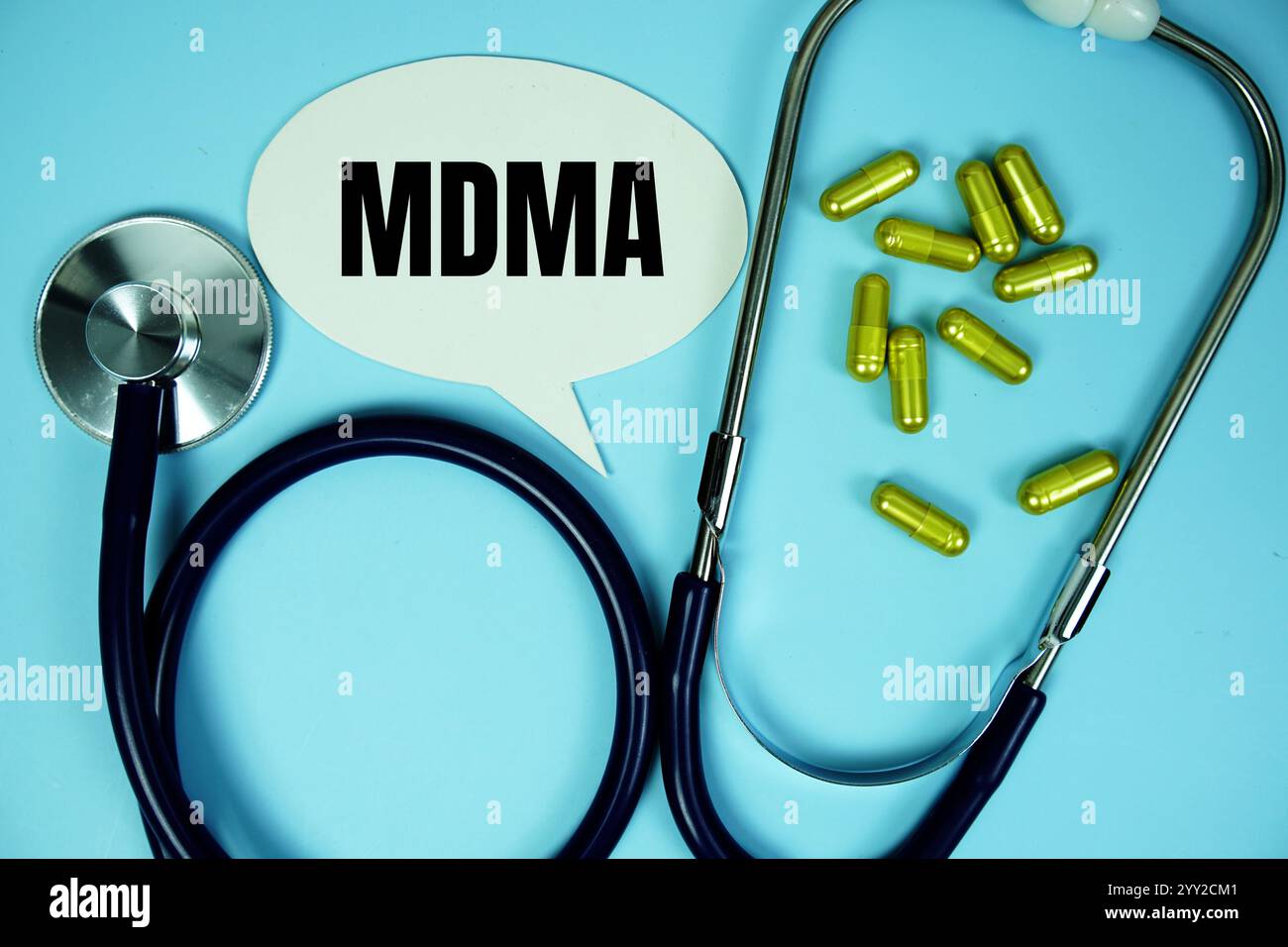 MDMA text with stethoscope and capsule medicine on blue background ...